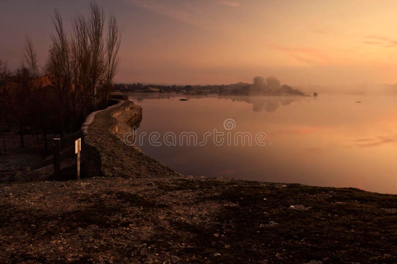 Lakeside View at Sunset with a Stone Path and Reflections. Stock Image ...