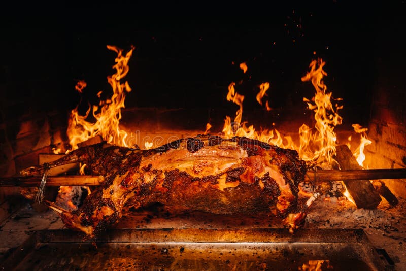 The Lamb is Cooked Entirely on a Spit on the Fire. Cooking Stock Photo ...