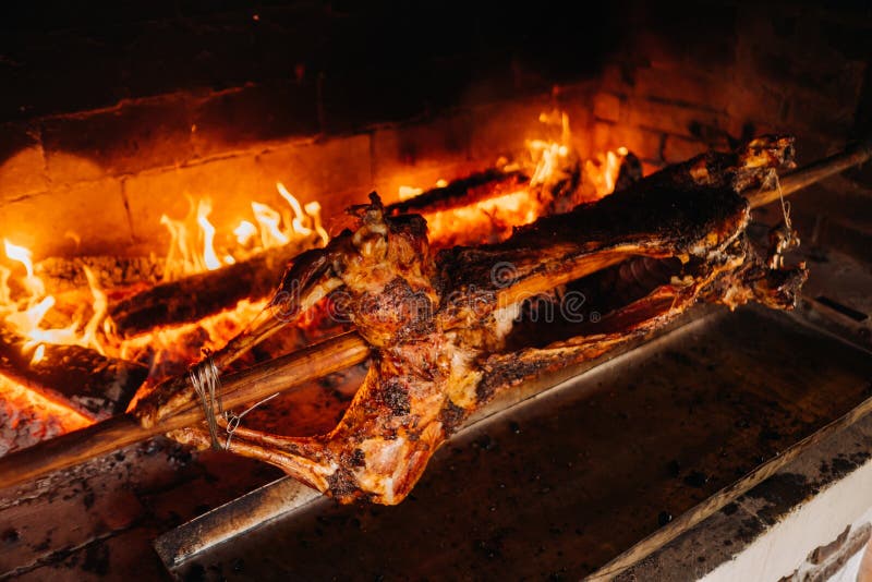 The Lamb is Cooked Entirely on a Spit on the Fire. Cooking Stock Image ...