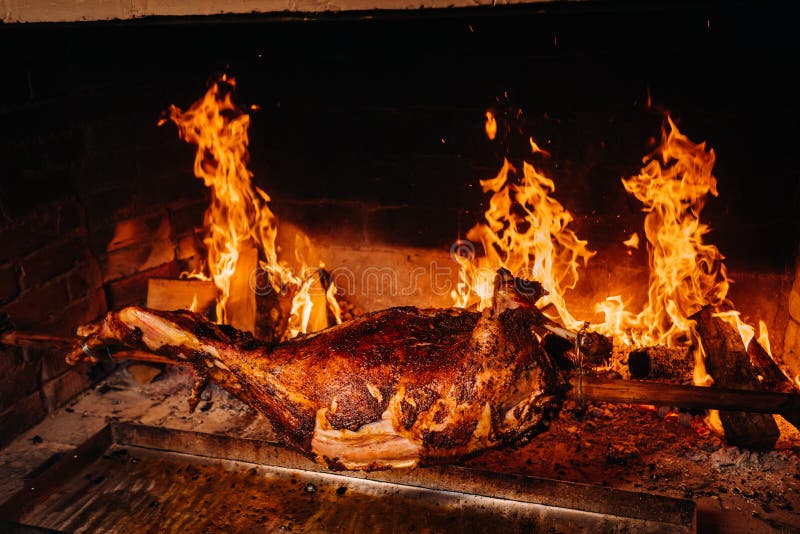The Lamb is Cooked Entirely on a Spit on the Fire. Cooking Stock Image ...