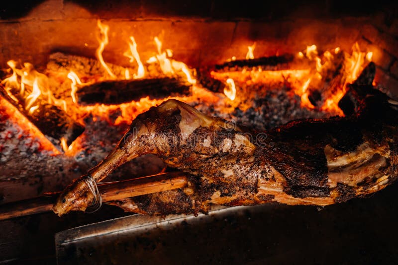The Lamb is Cooked Entirely on a Spit on the Fire. Cooking Stock Image ...