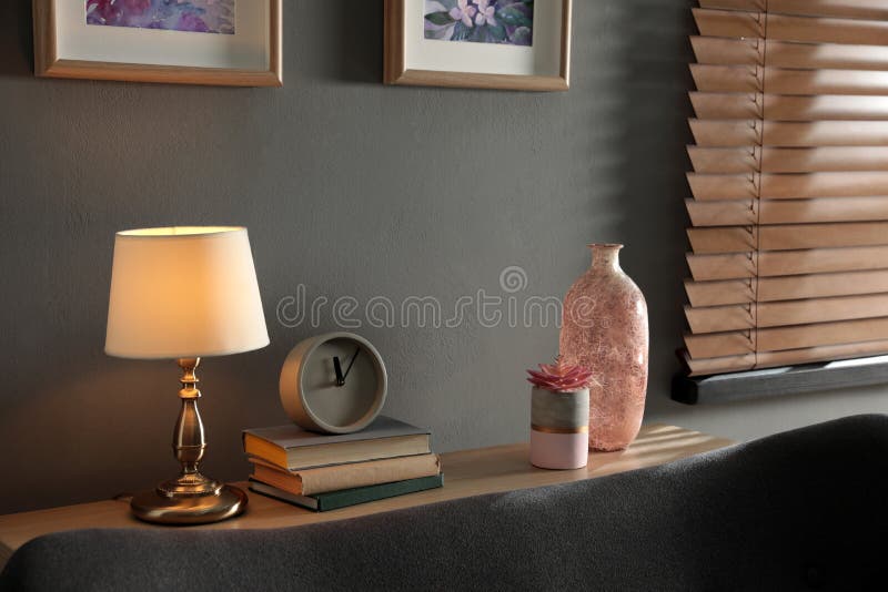 Lamp, Clock, Books and Decor Elements on Table in Living Room. Interior ...