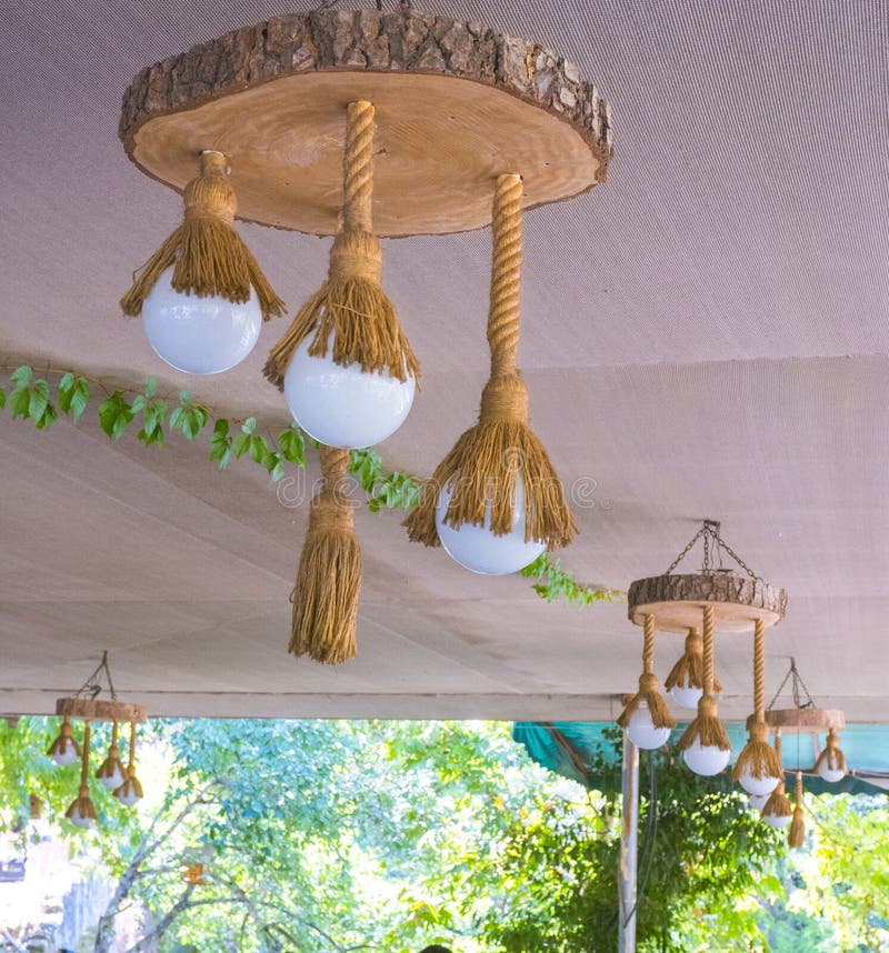 A Lamp of Electric Light in a Rope and Cut Down a Tree in a Summer ...