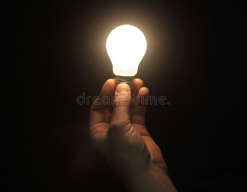 Lamp in hand stock photo. Image of closeup, electric - 65190788