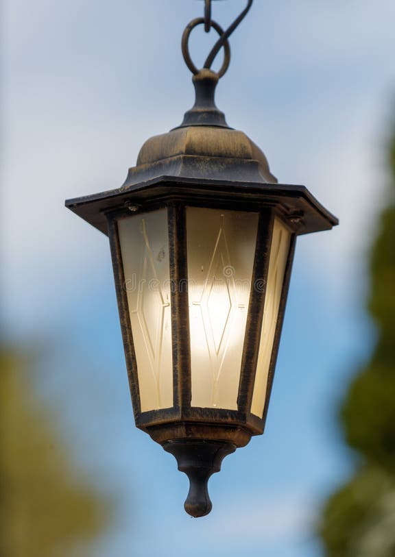 A Lamp Hanging from a Hook with a Light Shining on it Stock Image ...