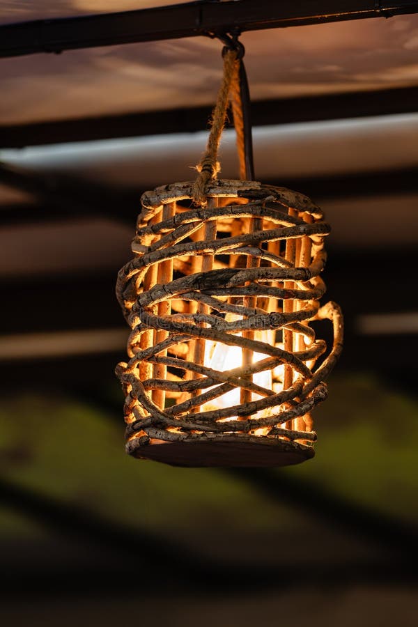 A Lamp Hanging from a Rope with a Light Inside Stock Photo - Image of ...