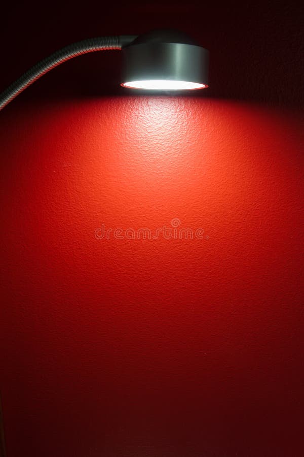 Lamp illuminating red wall stock photo. Image of electric - 28114426