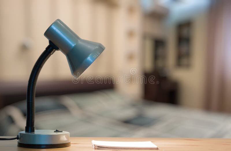 Lamp and notebook on table stock photo. Image of blank - 62846990