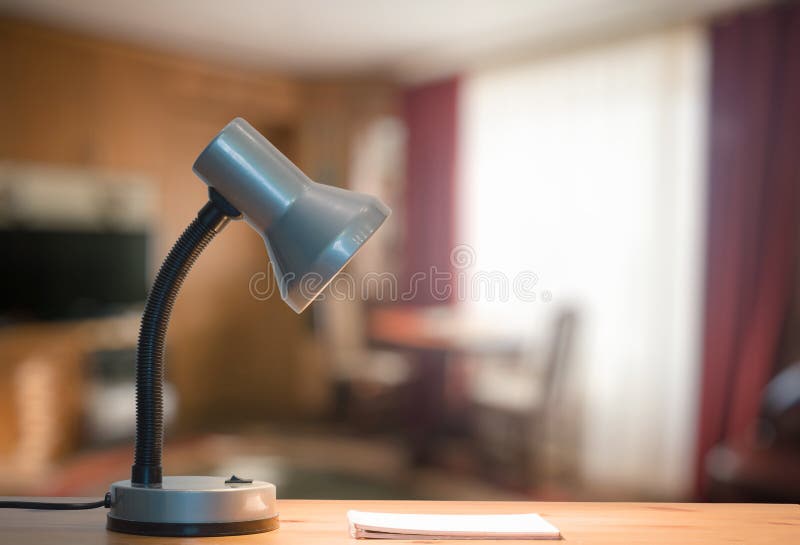 Lamp and notebook on table stock image. Image of vintage - 187127675