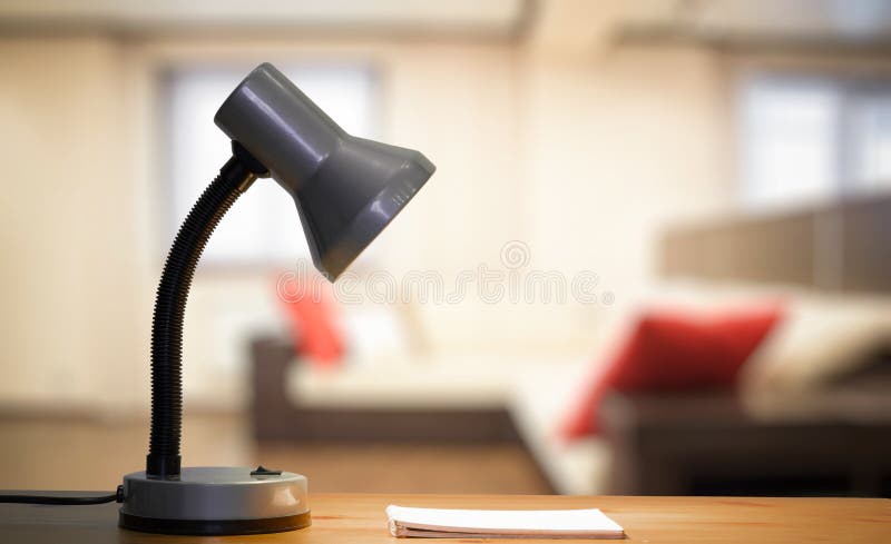 Lamp and notebook on table stock image. Image of interior - 207789869