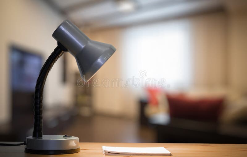 Lamp and notebook on table stock image. Image of notepad - 62887403
