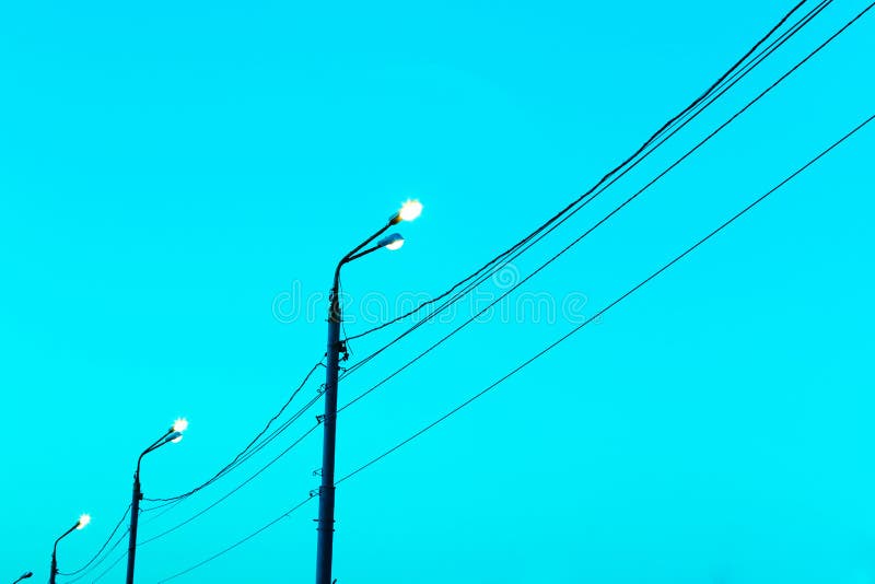 Lamp Poles with Power Lines on a Background of Blue Sky. Copy Space ...
