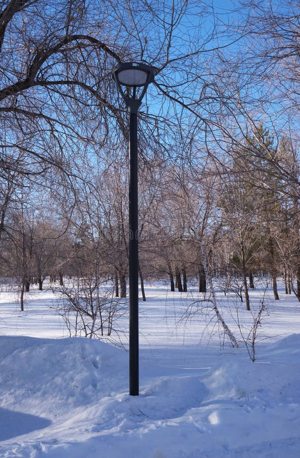 Lamp Post in a Public Snow-covered Park in Winter. Stock Image - Image ...