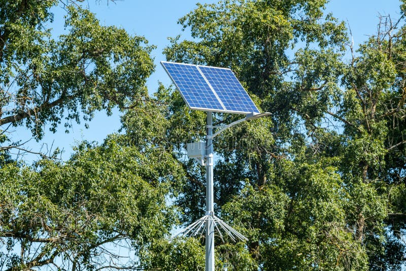Lamp Post with Solar Panel System on Road with Blue Sky and Trees ...