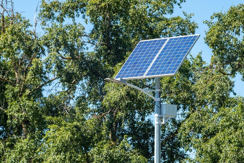 Lamp Post with Solar Panel System on Road with Blue Sky and Trees ...
