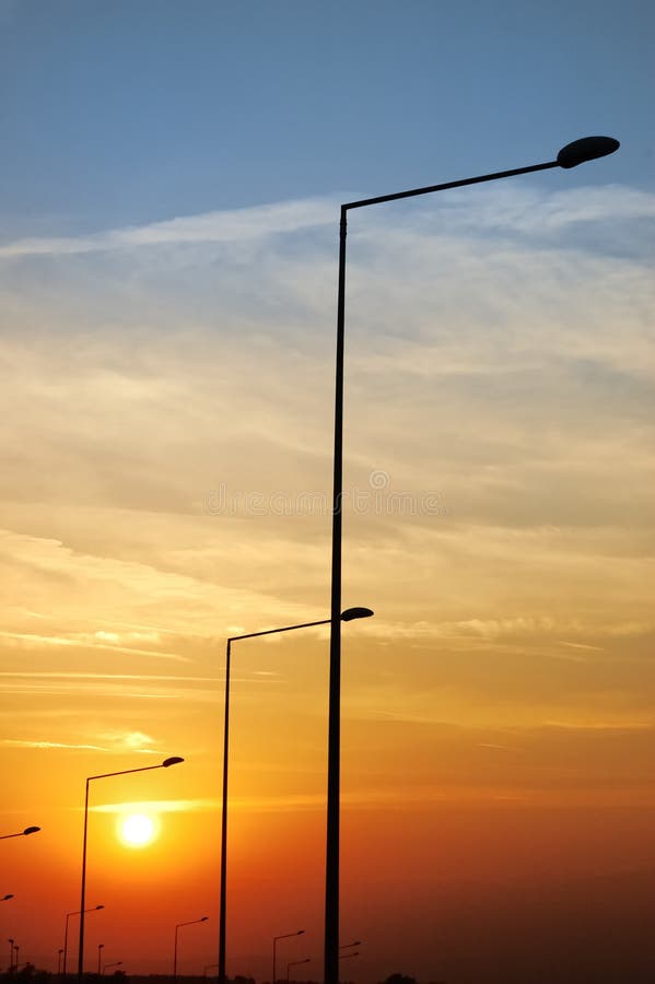 Lamp posts at sunset stock photo. Image of sunset, yellow - 3220792