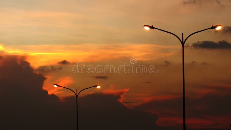 Lamp Posts on Sunset Twilight Stock Photo - Image of horizon, colorful ...
