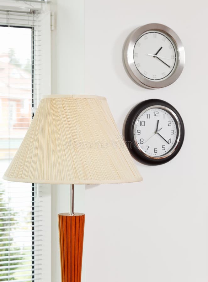 Lamp shade and wall clocks stock photo. Image of lamp - 17635198
