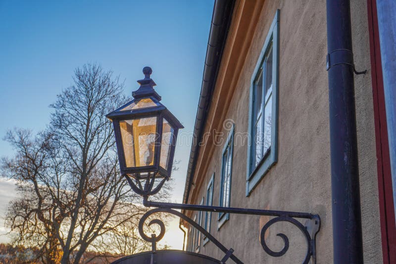 A Lamp on the Side of a Building Stock Photo - Image of person ...