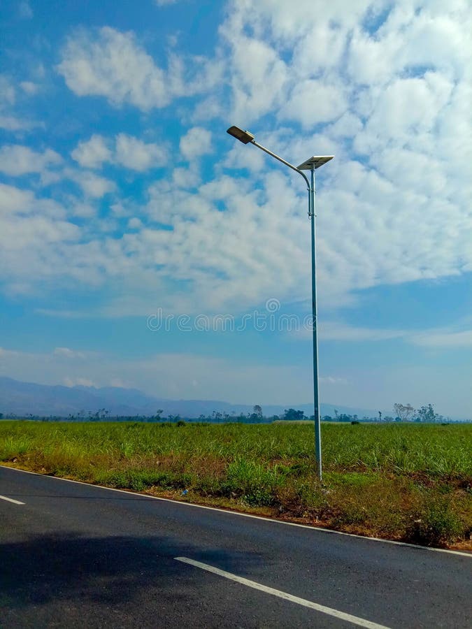 Lamp with Solar Panel System on Road with Blue Sky and Trees. from the ...