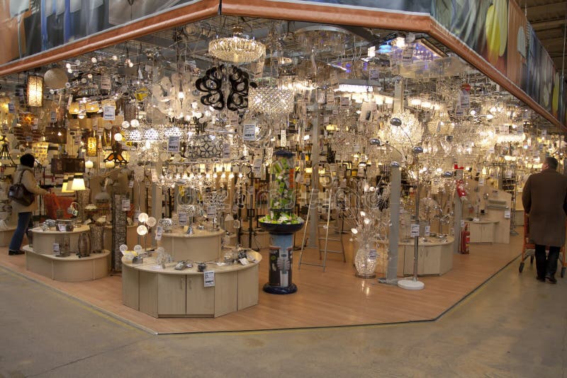 Pretty, Young Woman Choosing the Right Lamp for Her Apartment Stock ...