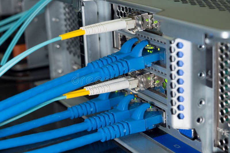 Lan and Fiber Optic Cables are Plugged into the Back Panal of the ...