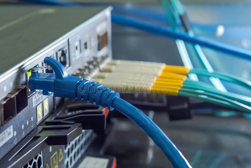 Lan and Fiber Optic Cables are Plugged into the Back Panal of the ...