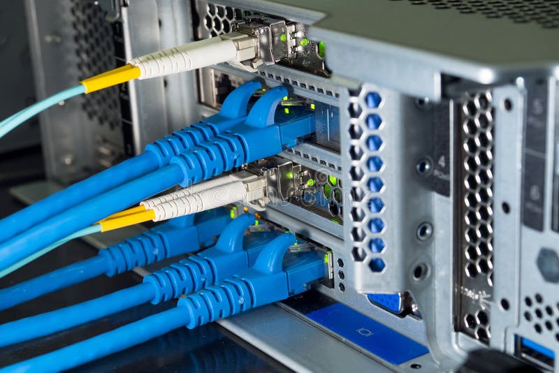 Lan and Fiber Optic Cables are Plugged into the Back Panal of the ...