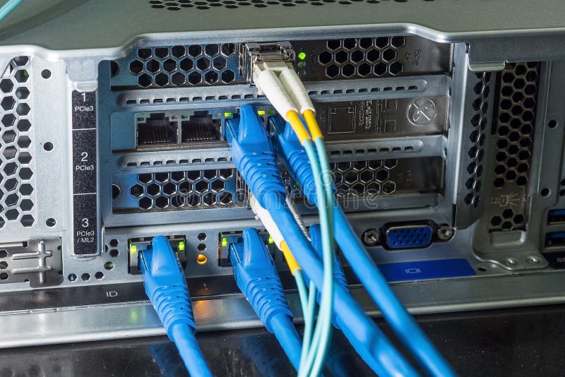 Lan and Fiber Optic Cables are Plugged into the Back Panal of the ...