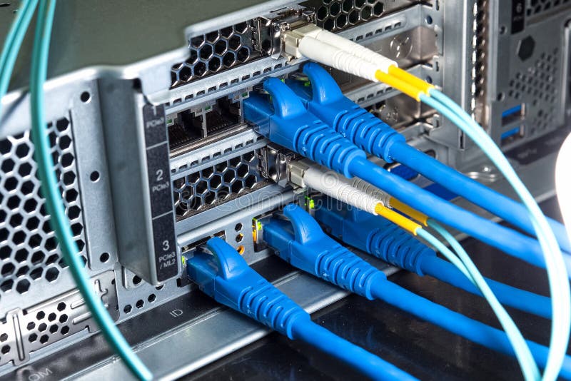 Lan and Fiber Optic Cables are Plugged into the Back Panal of the ...
