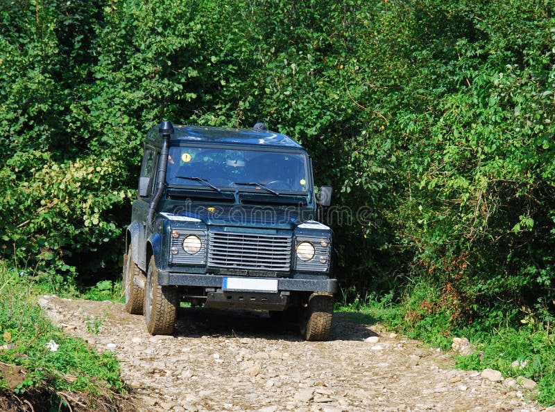 Land Rover on forest road stock image. Image of road - 12443379