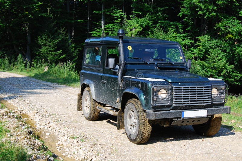 Land Rover on forest road stock photo. Image of driving - 12443428