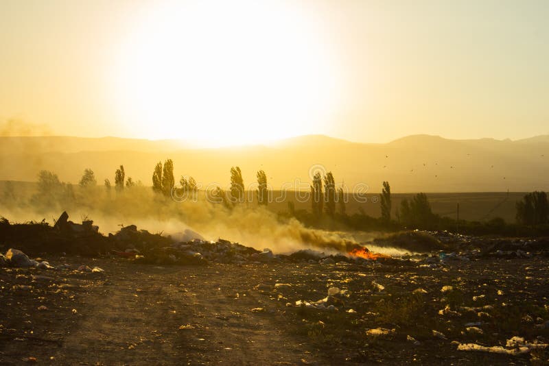 Dump fire at sunset stock photo. Image of garbage, dirty - 233881618