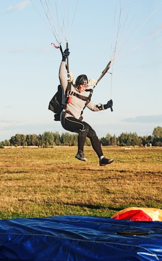 Parachutist Landing Under a Pink Parachute Stock Image - Image of ...