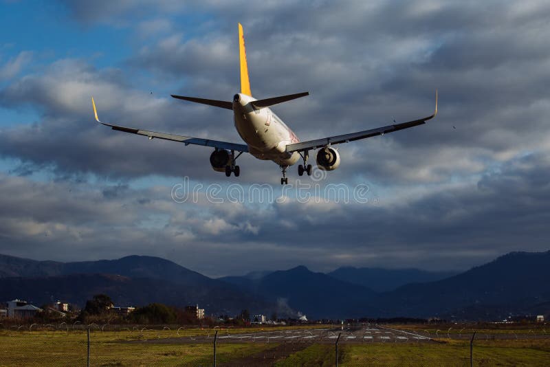 Landing Plane on Cloudy Sky Background, Rear View Stock Photo - Image ...