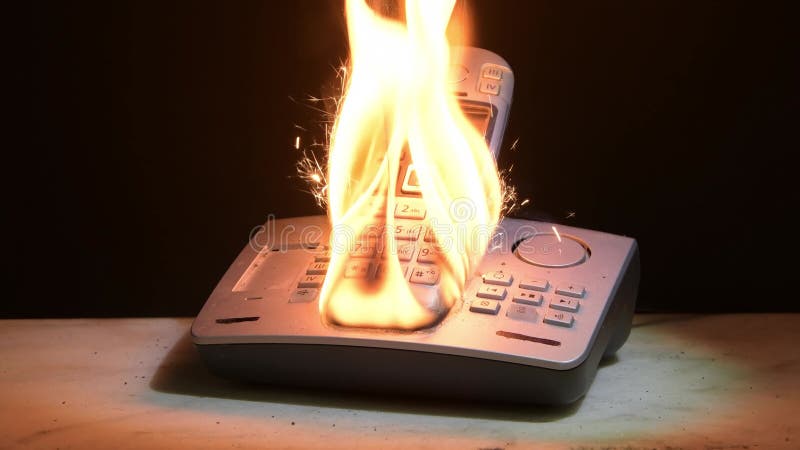 A Landline Phone is Engulfed in Bright Flames and Sparks during a Fire ...