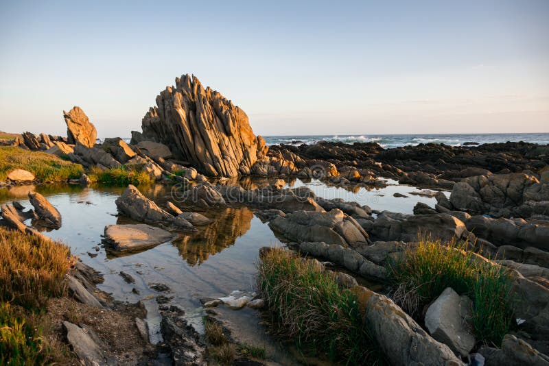 Landscape at the Beach with the Reflection of the Rocks in the Water ...