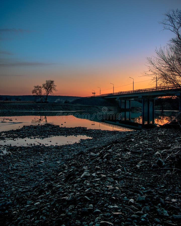 Landscape Bridge Over a River with a Mirror-smooth Surface during Sunset. Stock Photo - Image of ...