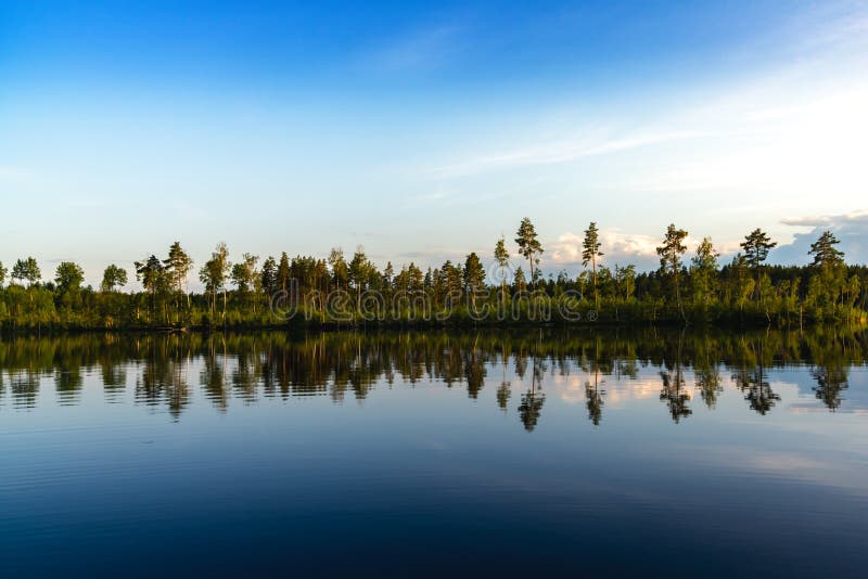 Calm Idyllic Deep Blue Lake with Forest on the Shore and Reflections of ...