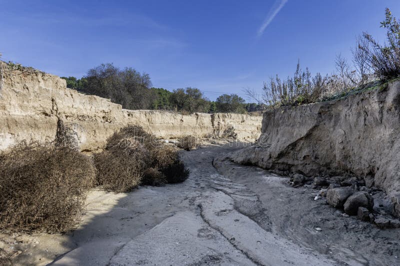 A Landscape of a Dry Stream Basin with the Bed Covered in Sand and ...