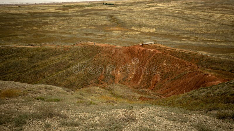 The Landscape Features a Depression in the Grassland with Red Soil, Set ...