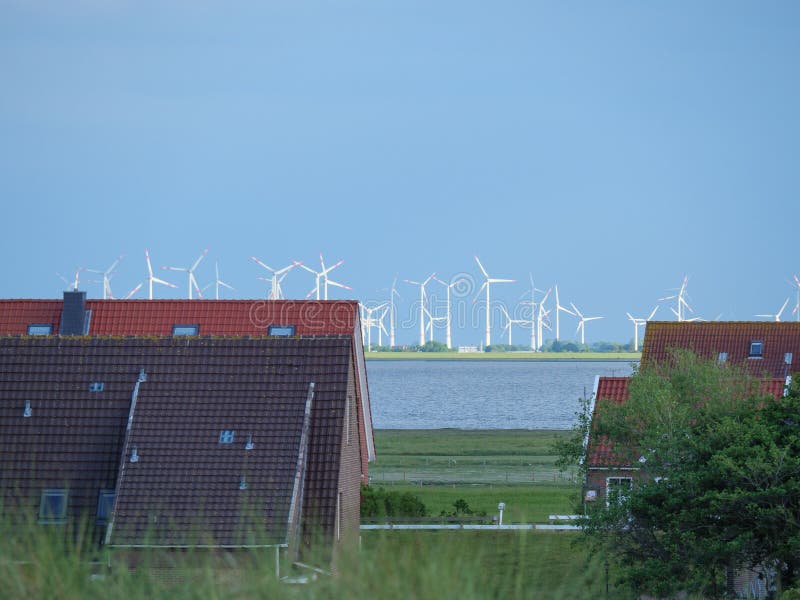 Landscape Featuring Several Residential Homes, with an Array of Wind ...