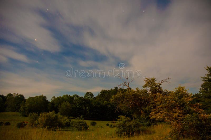 Field landscape at night stock image. Image of clouds - 108109799
