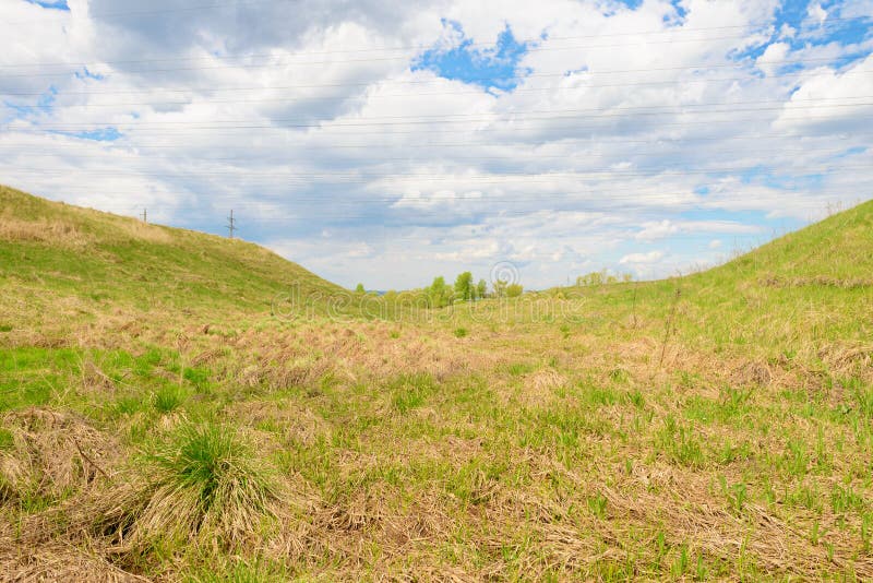 Landscape with Grass in a Ravine and Power Lines Stock Photo - Image of ...