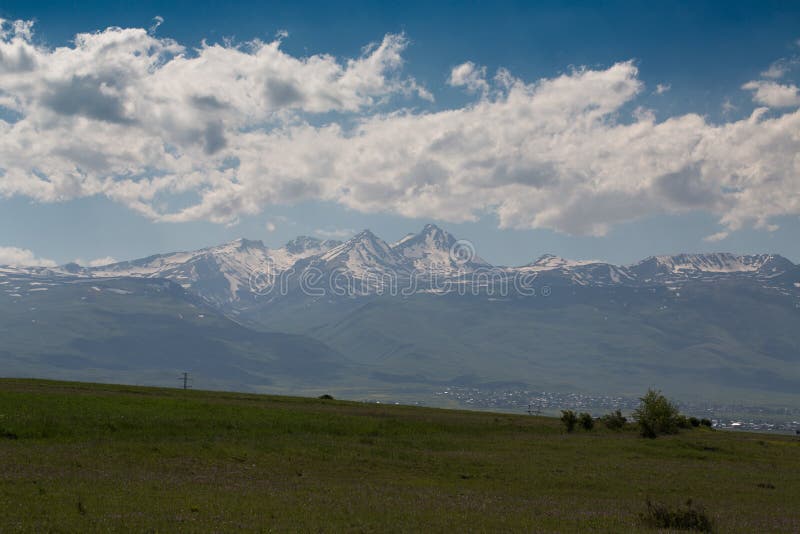 Landscape of Green Field and Also Mountains and Clouds Stock Photo ...