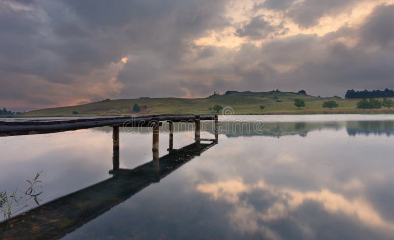 Landscape of a Jetty on a Dam with Dramatic Clouds of Rain Storm Stock ...
