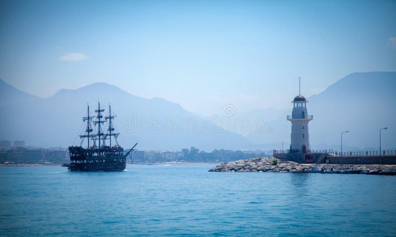 Landscape of Medieval Lighthouse and Three-masted Vintage Ship Stock ...