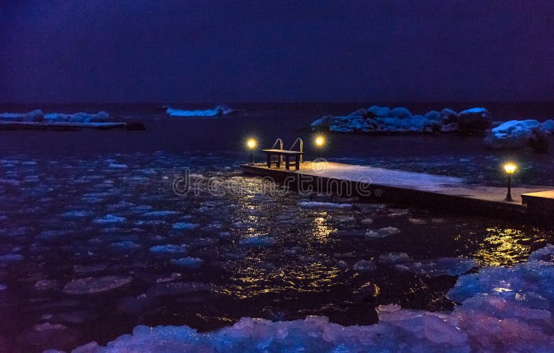 Landscape with Night Lake with Lights on a Pier and Floating Ice Stock ...