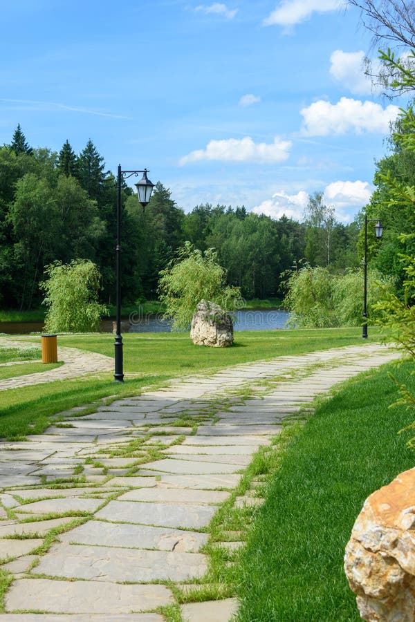 Landscape in a Park with Stone Path Leading To a Pond. Stock Image ...