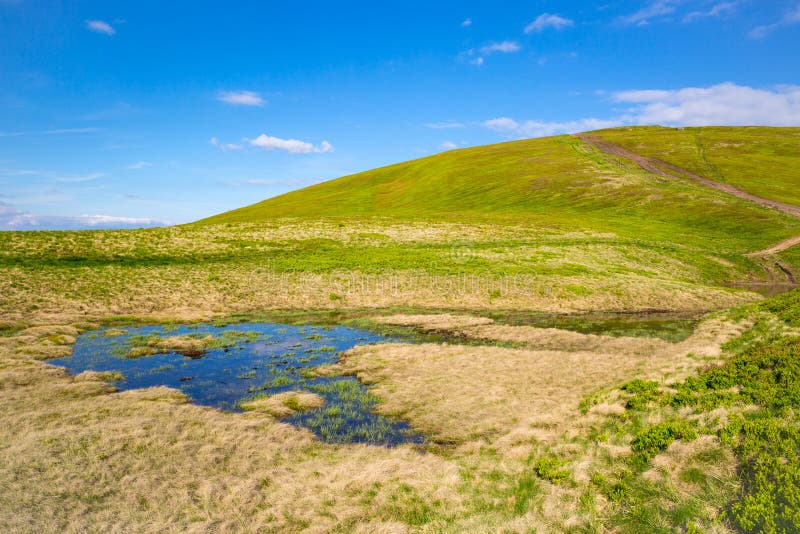 Puddle on mountain meadow stock photo. Image of tourism - 122118780